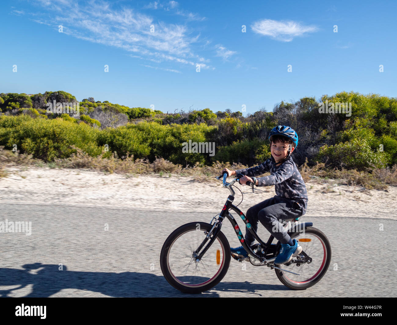 Young boy riding bike against nature background Stock Photo - Alamy