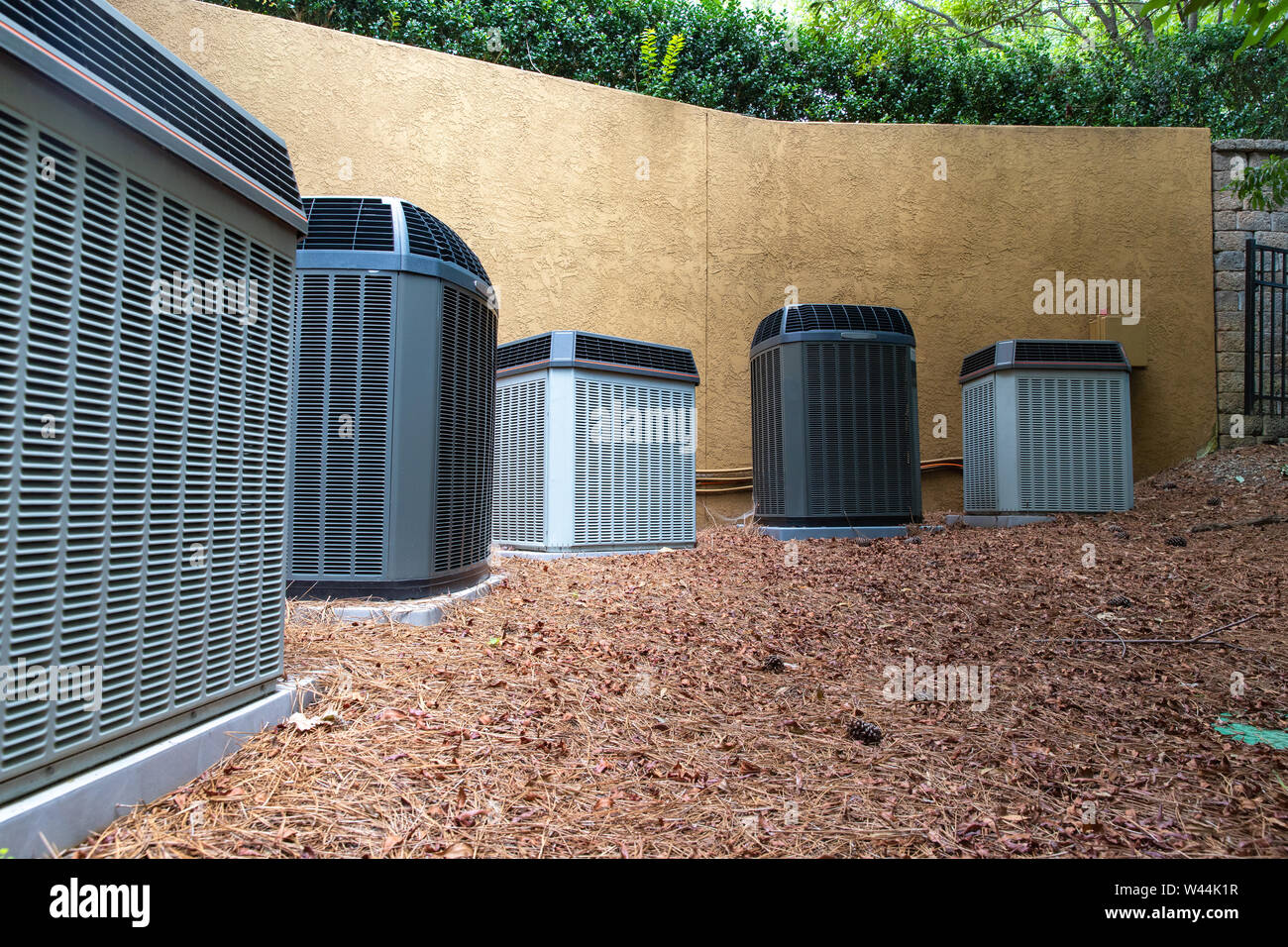 Multiple Air Conditioner Compressors next to large house or building ...