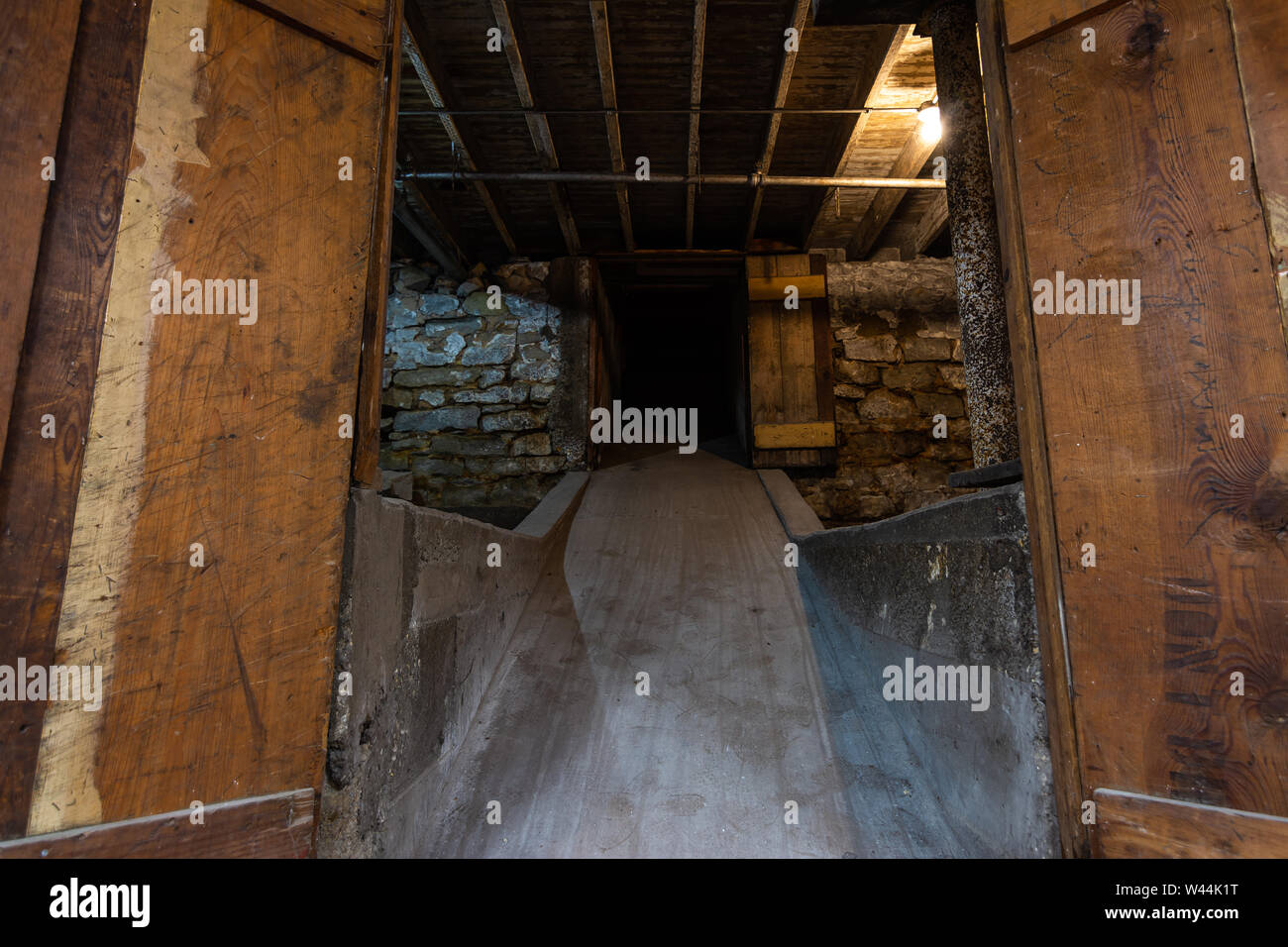Old concrete loading chute in warehouse basement Stock Photo - Alamy