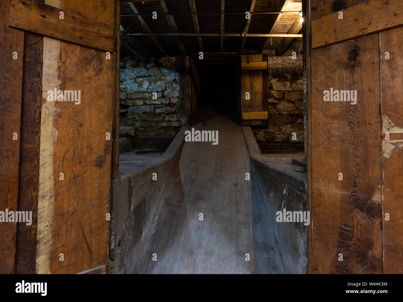 Old concrete loading chute in warehouse basement Stock Photo - Alamy