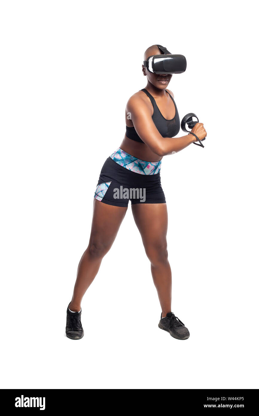 Black African American woman working out by playing a VR dancing rhythm ...