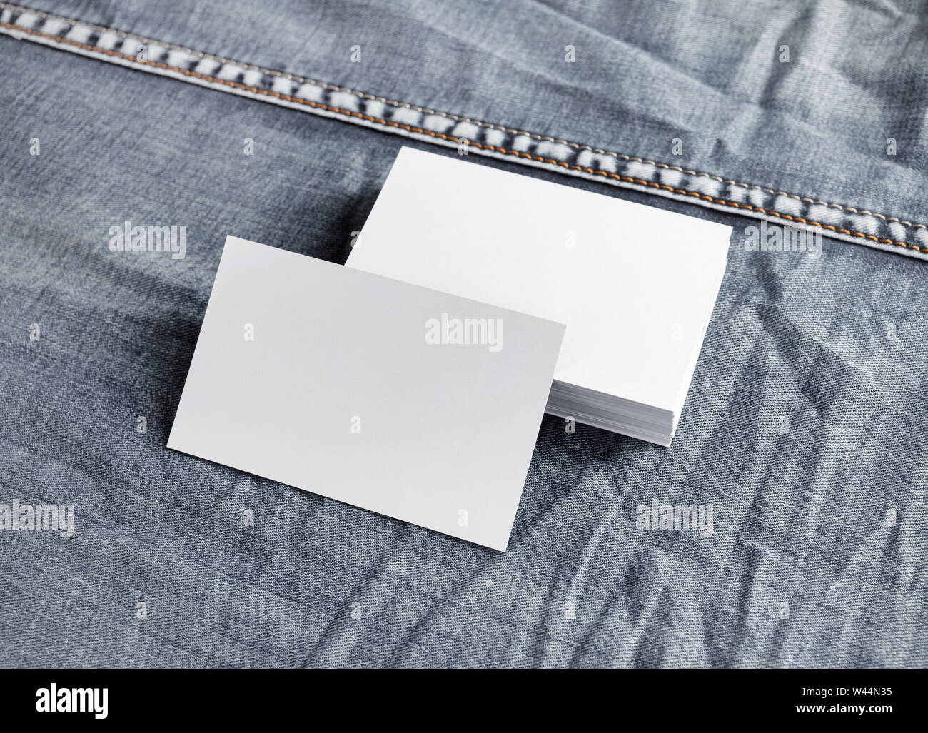 Photo of blank white business cards on denim background Stock Photo - Alamy