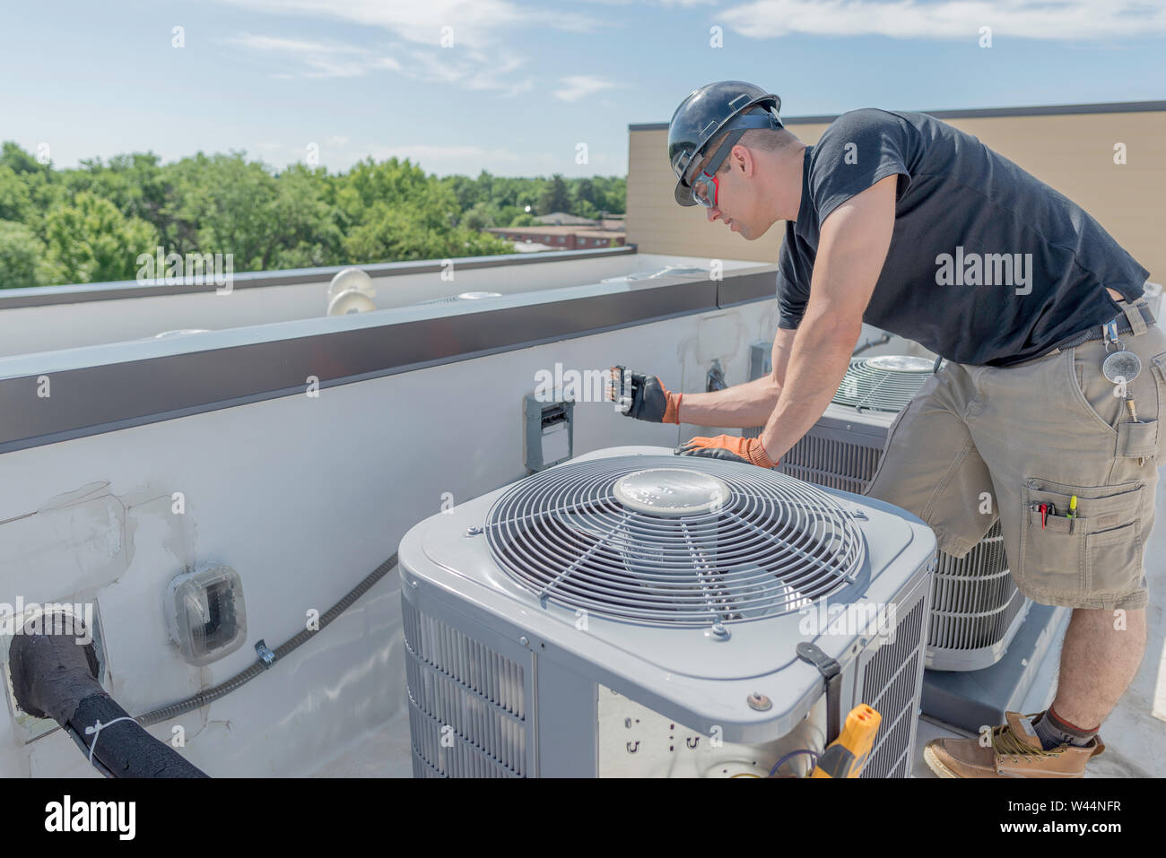 Hvac technician pulling a breaker on a condenser Stock Photo - Alamy
