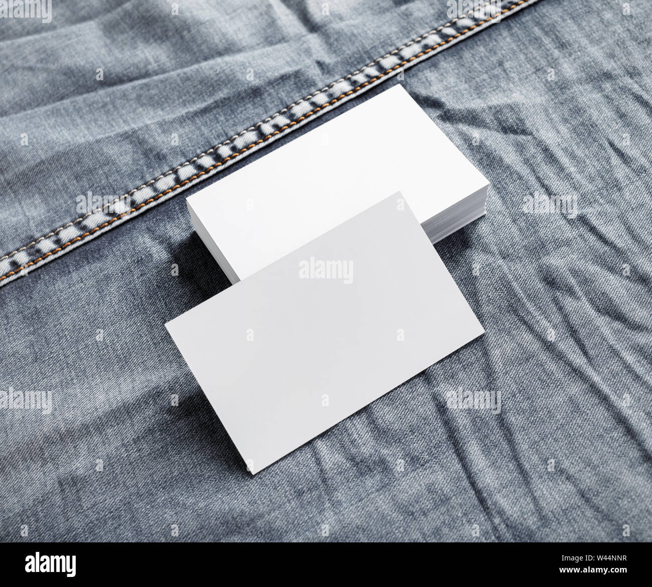 Blank name cards template. White paper business cards on denim ...
