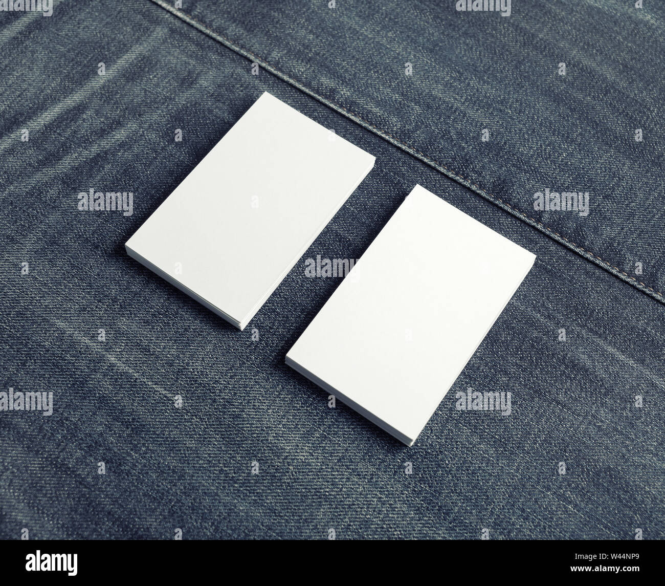 Photo of blank business cards on denim background Stock Photo - Alamy