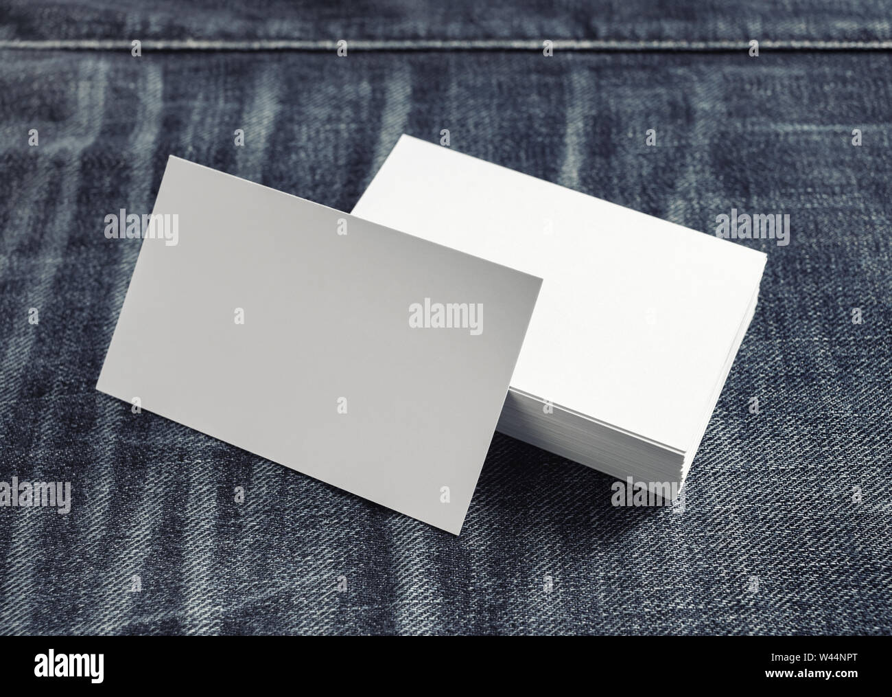 Photo of blank white business cards on denim background Stock Photo - Alamy