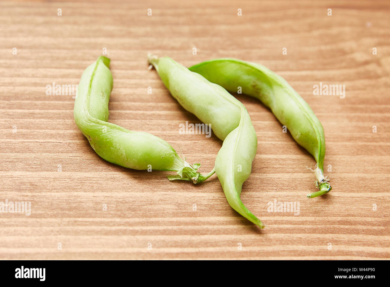 Ugly organic home grown pea on brown wooden background.Trendy ugly food ...