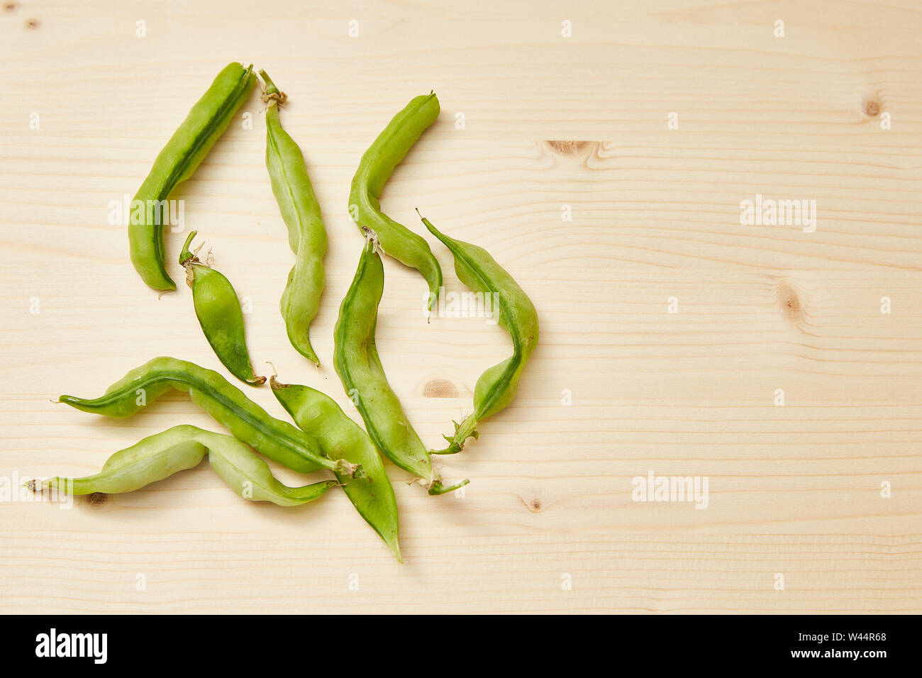 Ugly organic home grown pea on wooden background. Trendy ugly food ...