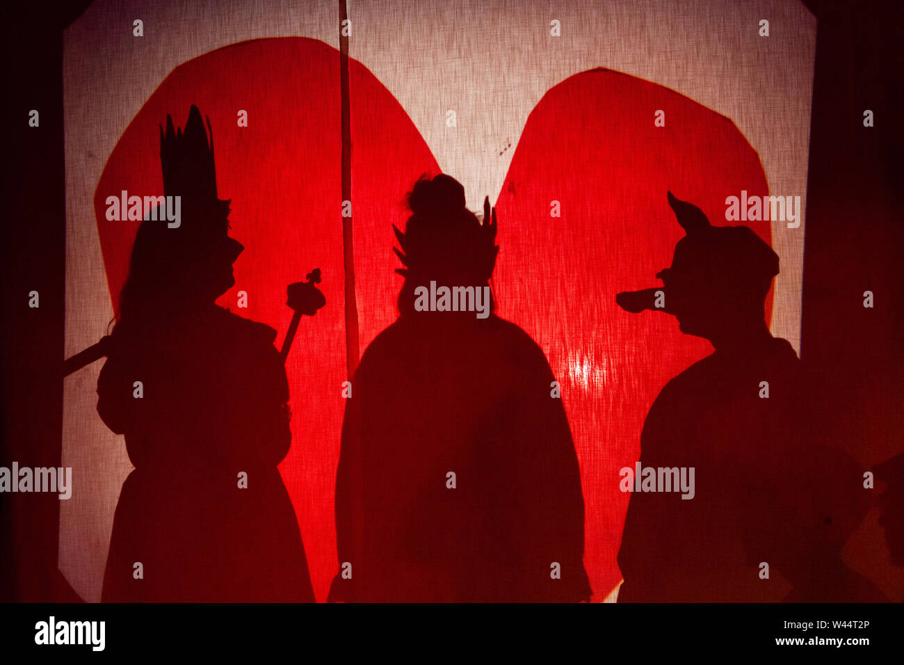 Young kids are seen casting silhouettes onto a curtain, backlight ...