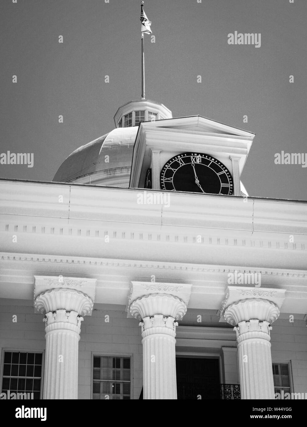 The flags, the cupola, the clock tower & columns of the Neoclassical ...
