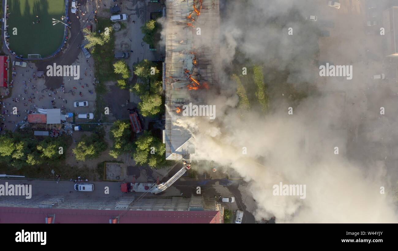 Burning roof of a residential high-rise building, clouds of smoke from ...