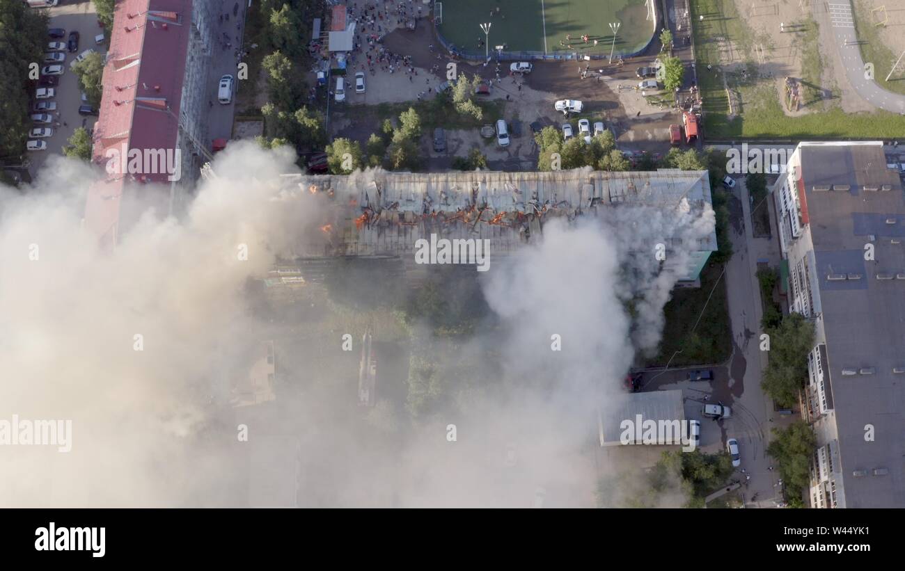 Burning roof of a residential high-rise building, clouds of smoke from ...