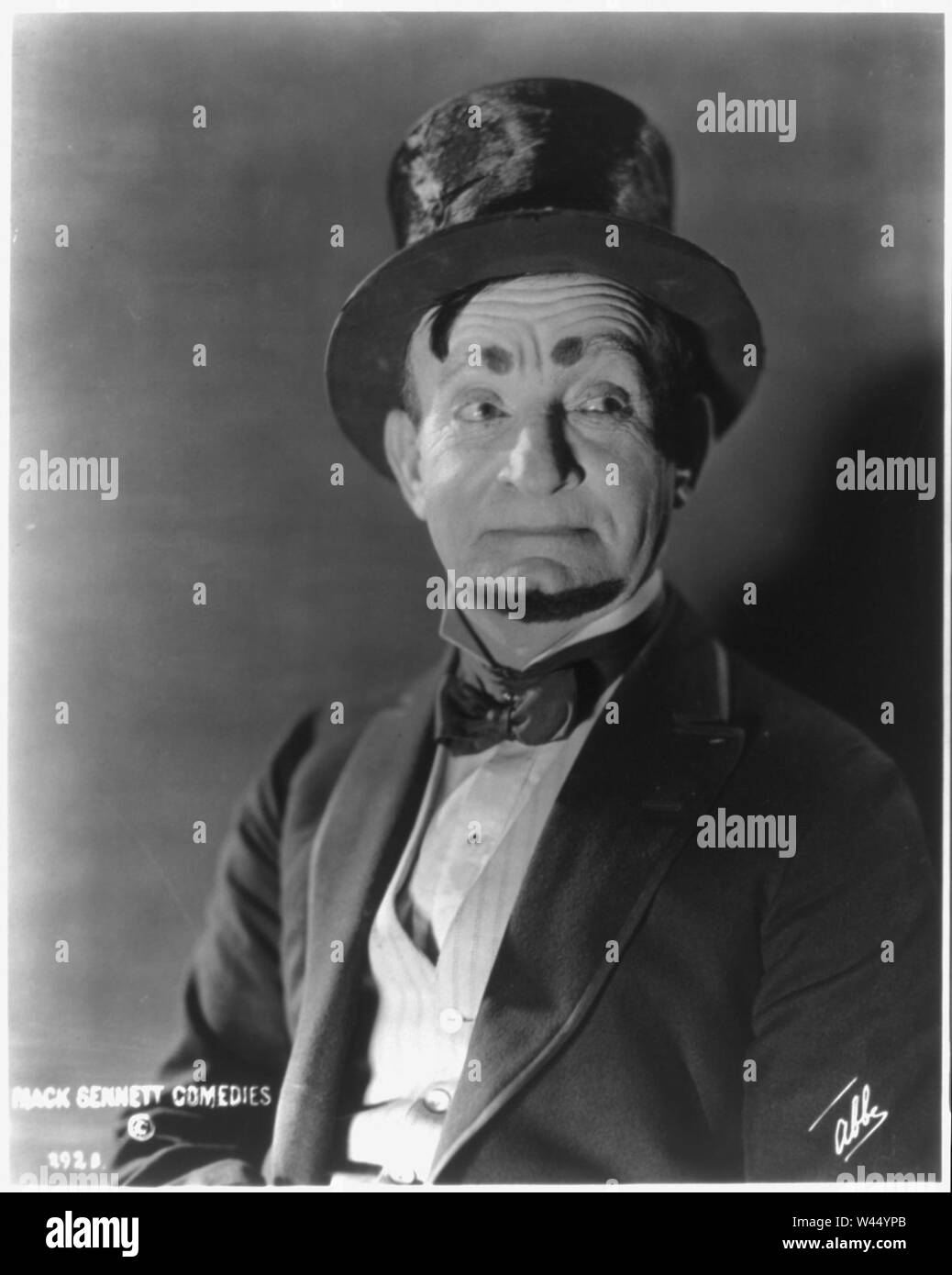 Comedian with small beard, wearing top hat and bowtie, half lgth ...