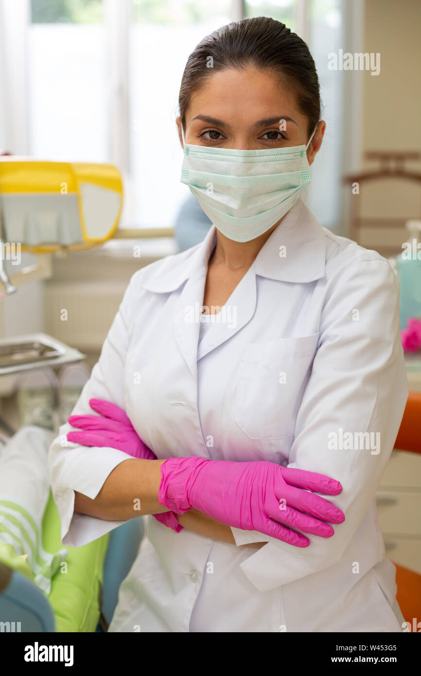 Doctor with arms crossed in a dentist office Stock Photo - Alamy