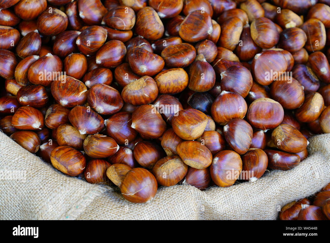 Fresh chestnuts in the shell at a farmers market Stock Photo - Alamy