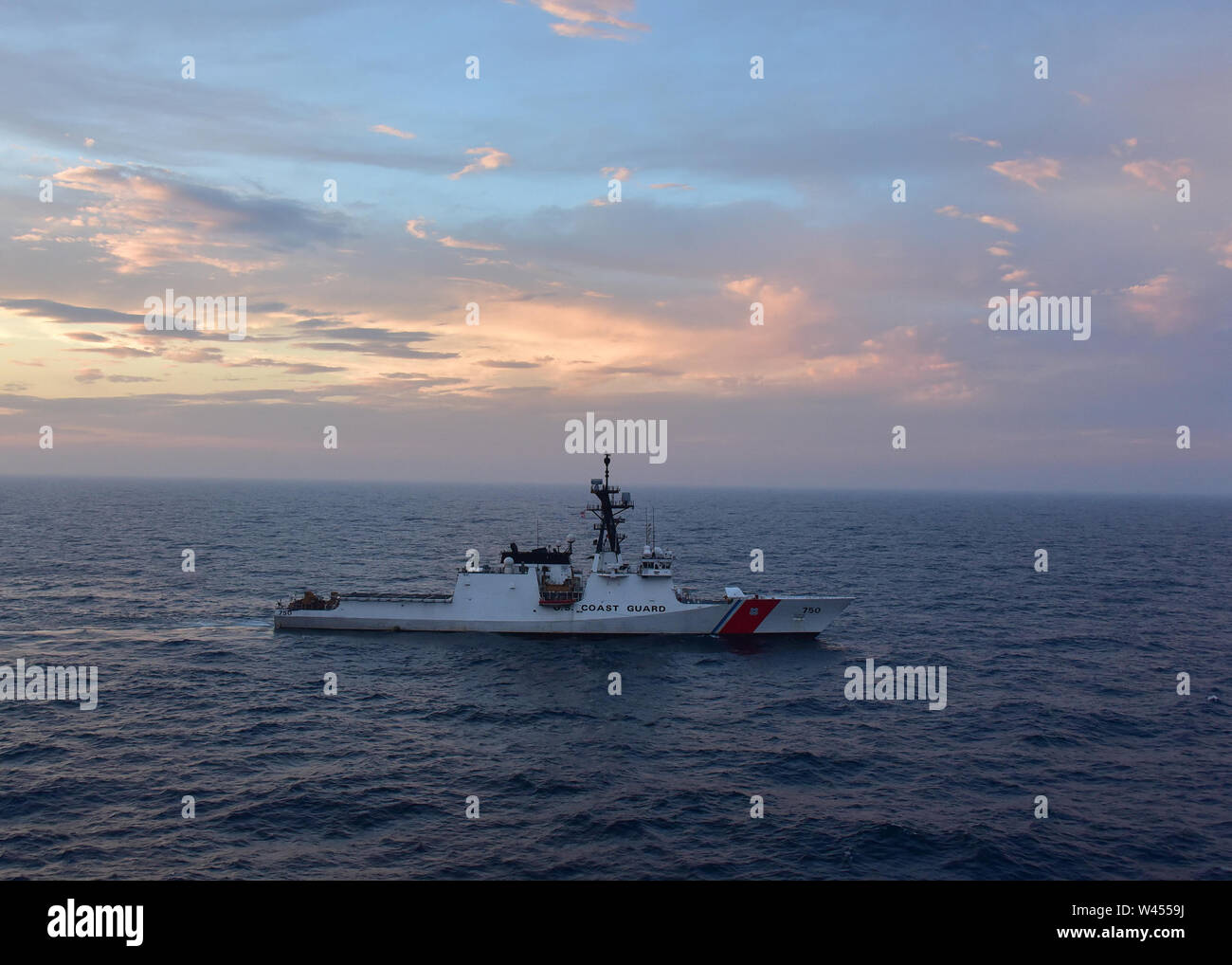 U.S. Coast Guard Cutter Bertholf (WMSL 750) basks in a sunset glow in ...