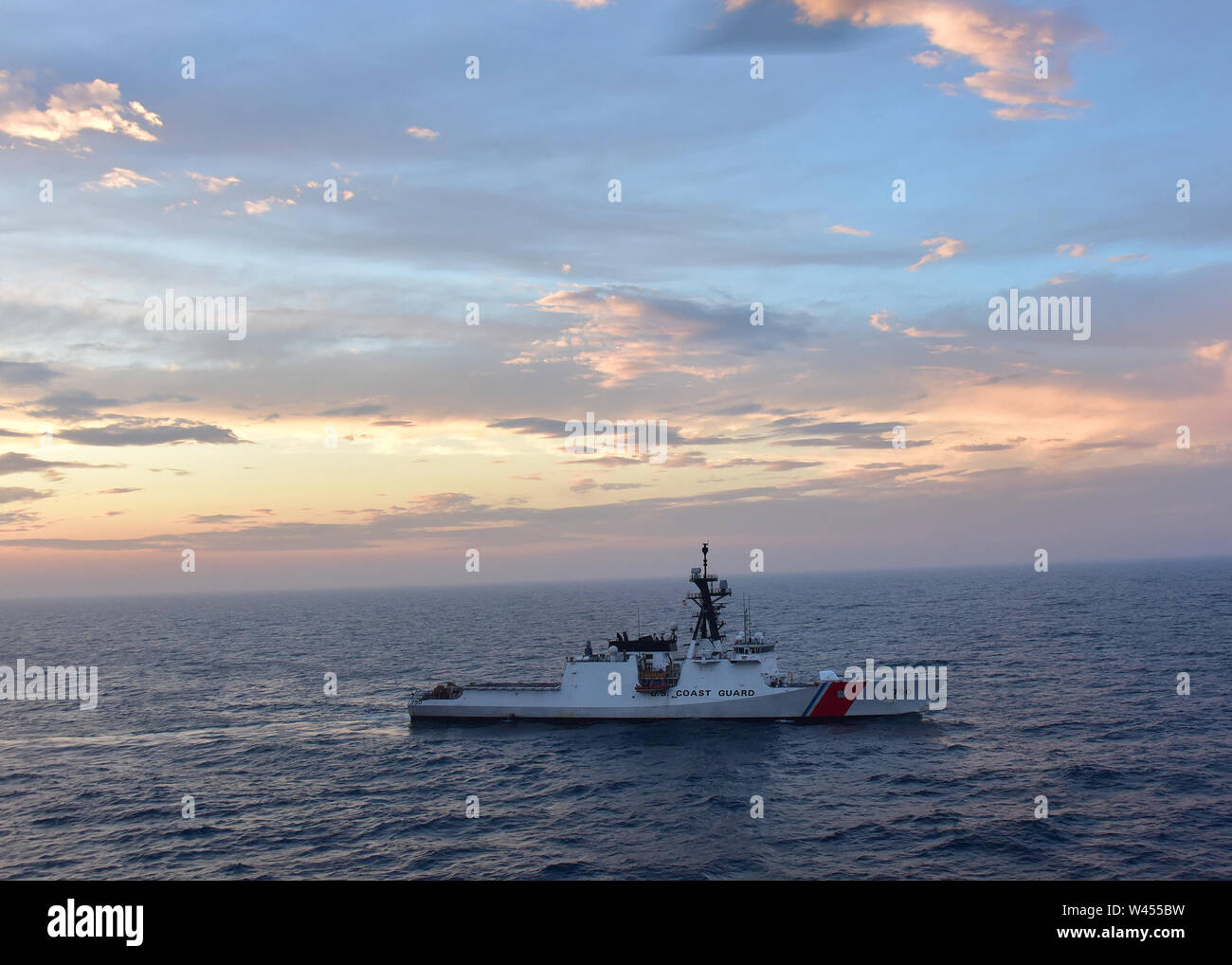 U.S. Coast Guard Cutter Bertholf (WMSL 750) basks in a sunset glow in ...