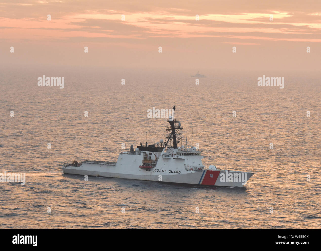 U.S. Coast Guard Cutter Bertholf (WMSL 750) basks in a sunset glow in ...