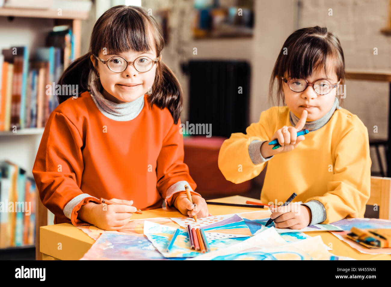 Positive little girls being busy with painting Stock Photo - Alamy