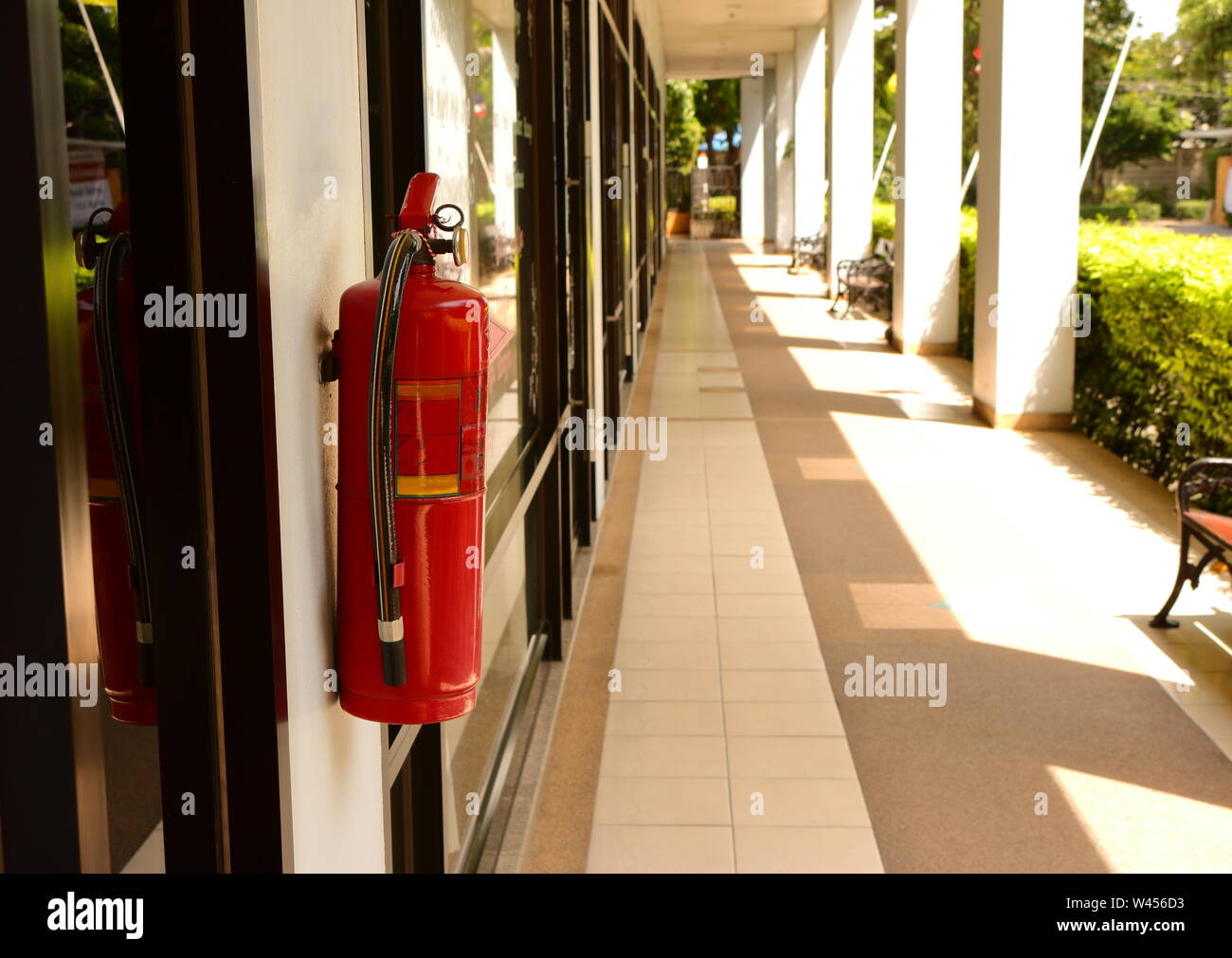 Closeup of fire extinguisher hanging on the wall of a building, safety ...