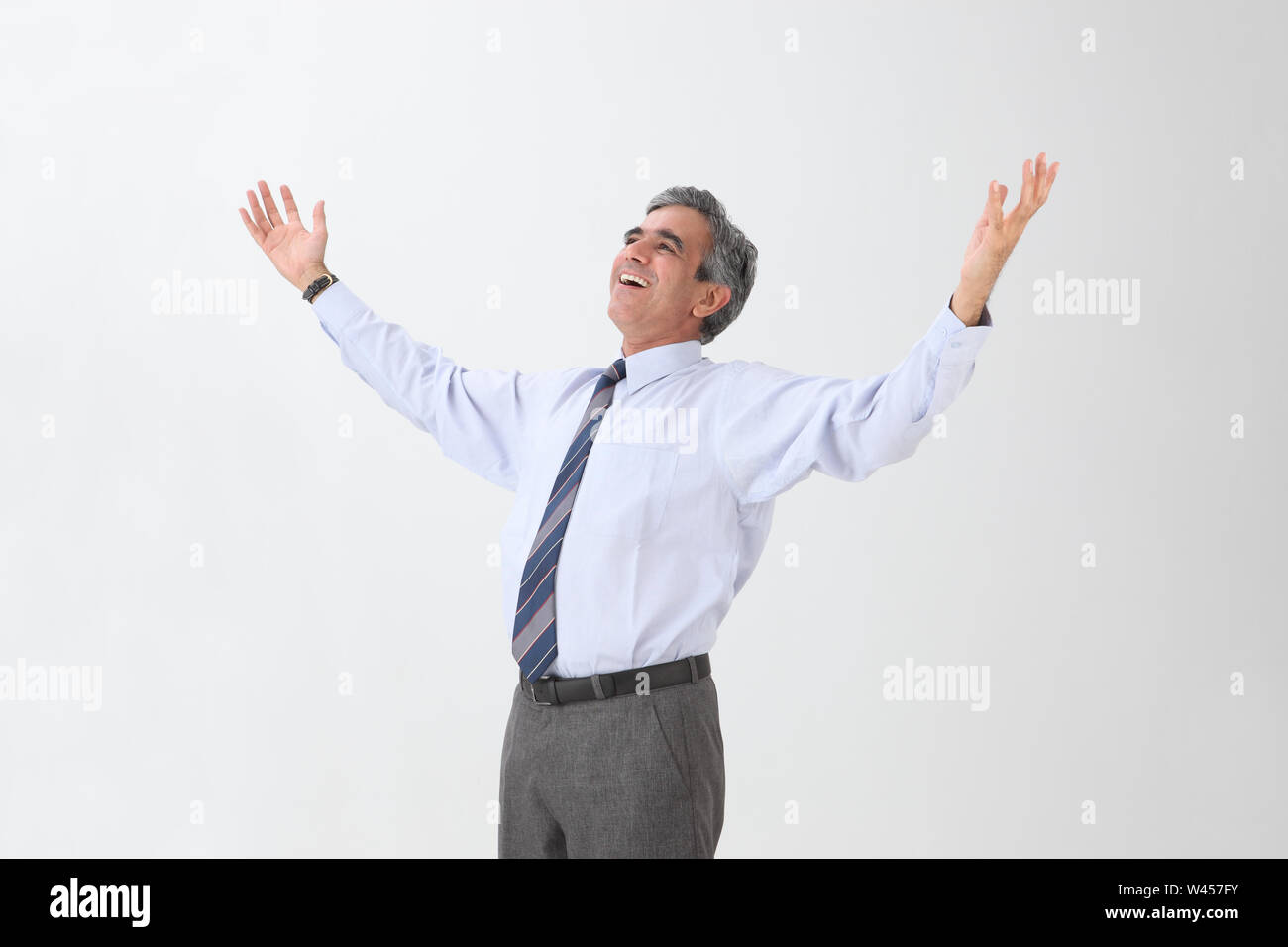 Businessman standing with his arms outstretched Stock Photo - Alamy
