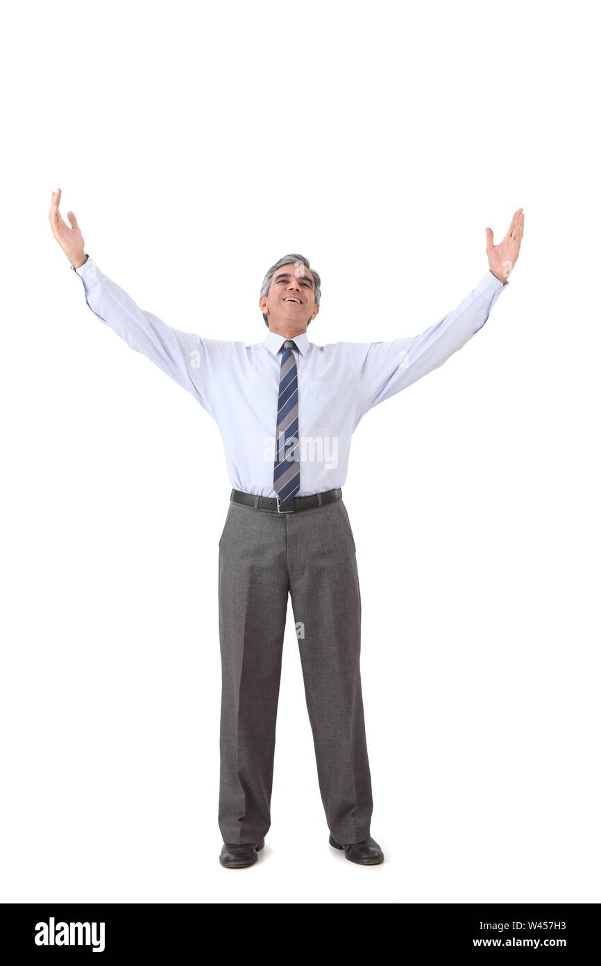 Businessman standing with his arms outstretched Stock Photo - Alamy
