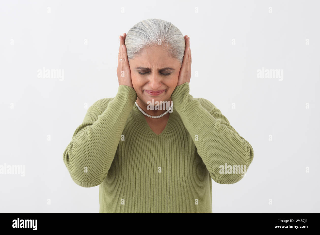 Woman covering ears with hands Stock Photo - Alamy