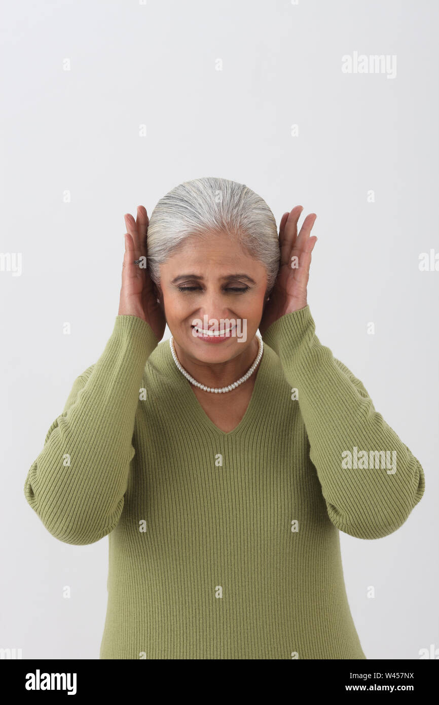 Woman covering ears with hands Stock Photo - Alamy