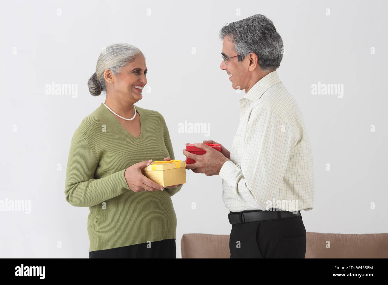 Couple giving gifts to each other Stock Photo - Alamy