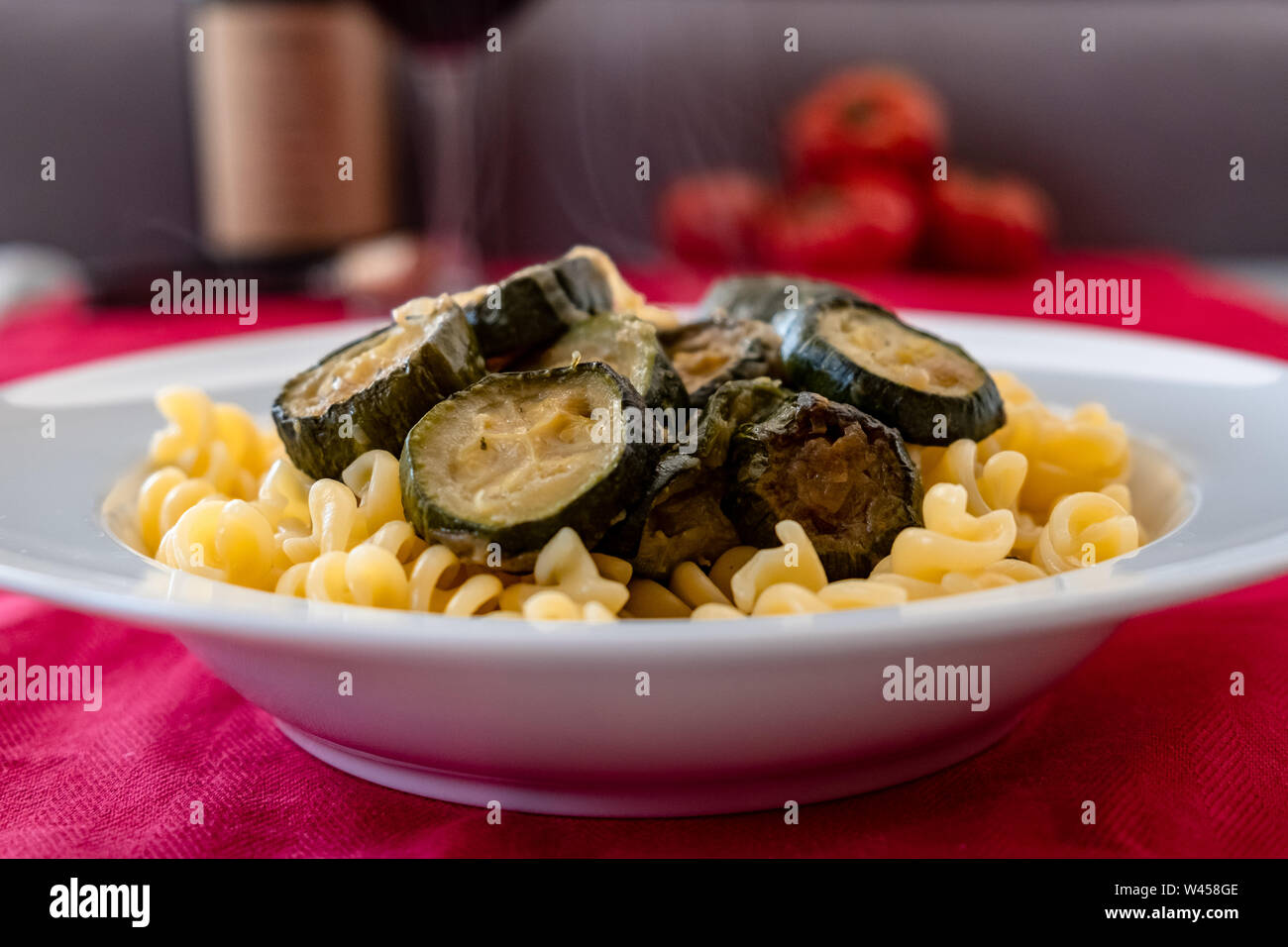 Pasta with zucchini on an italian table Stock Photo - Alamy