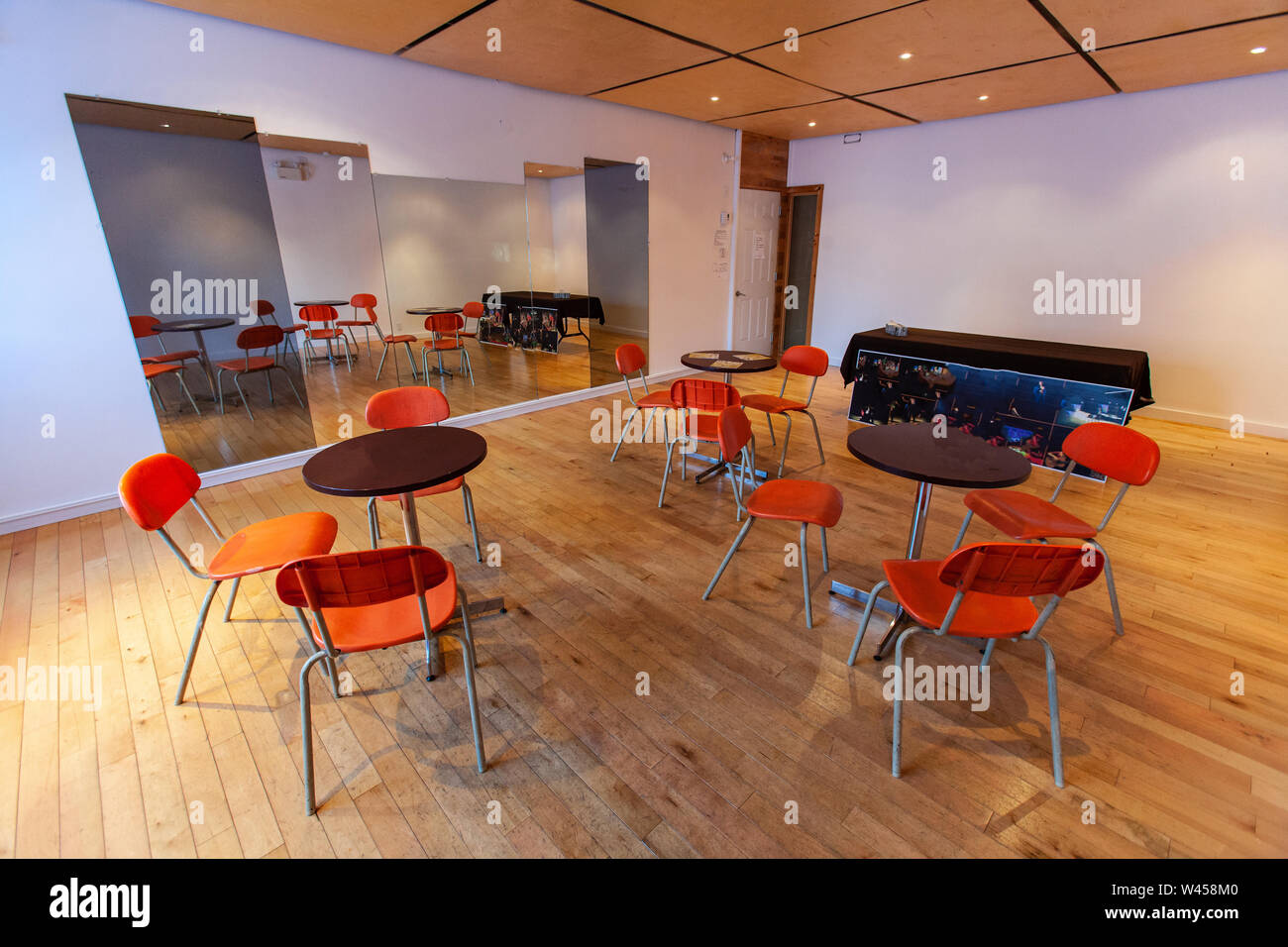 A wide angled view of empty tables and chairs set out in a function ...