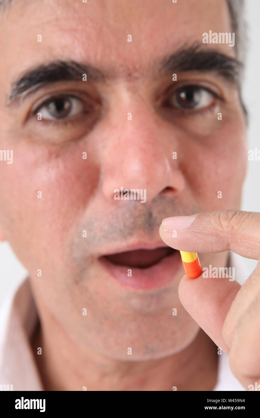 Indian old man taking medicine hi-res stock photography and images - Alamy