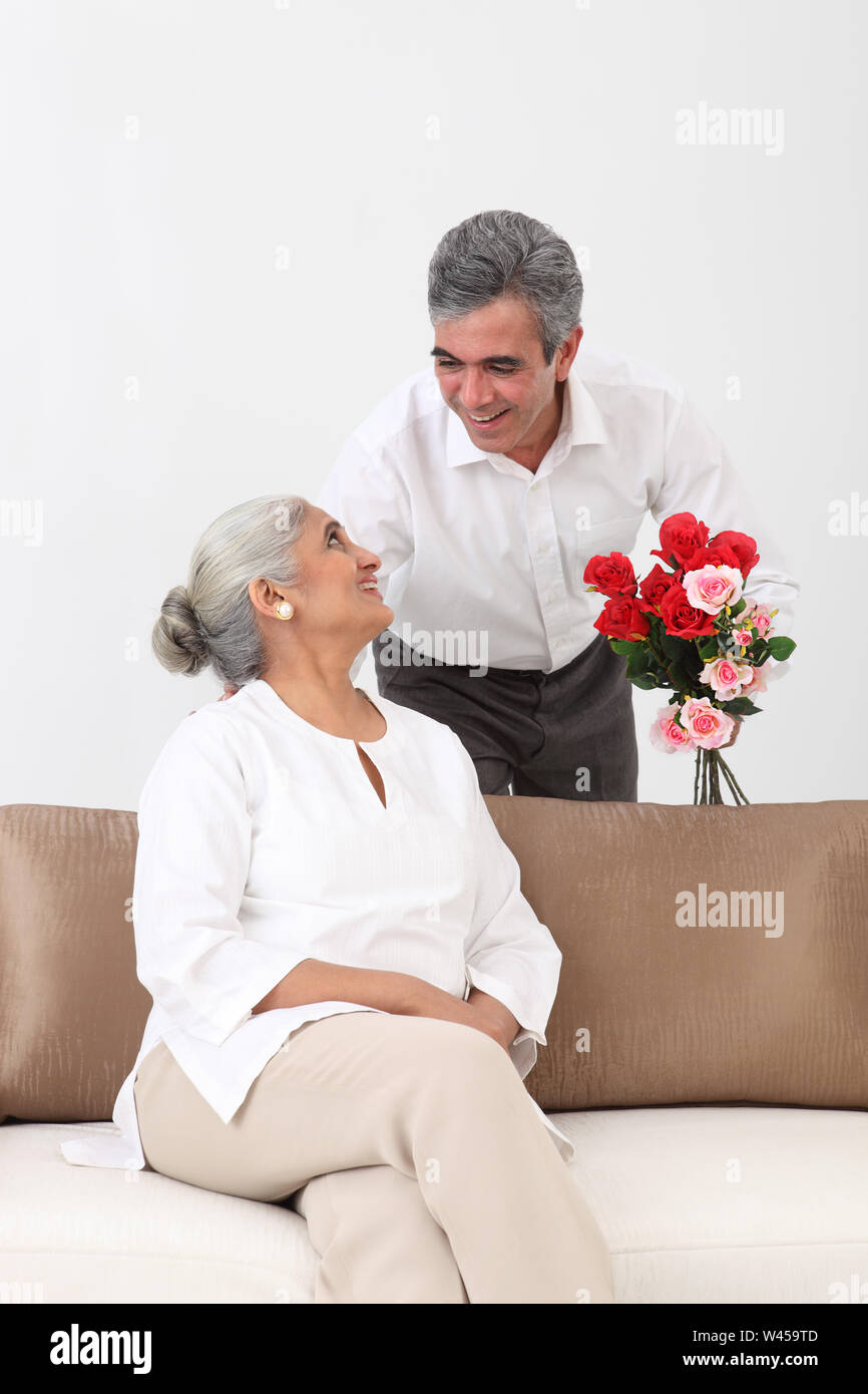 Indian man giving bunch flowers hi-res stock photography and images - Alamy
