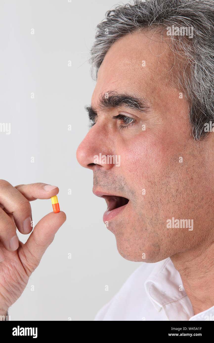 Indian old man taking medicine hi-res stock photography and images - Alamy