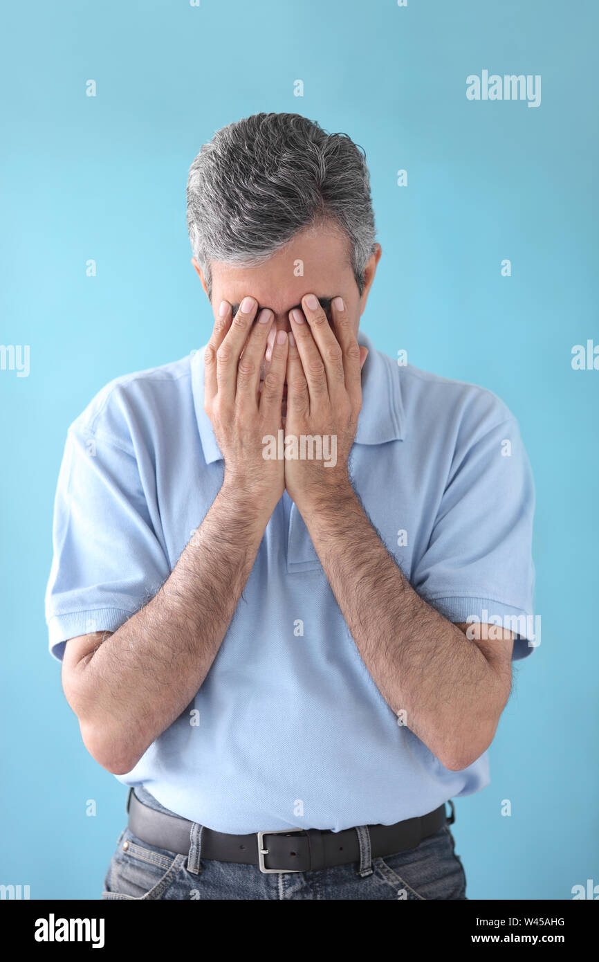Man covering his face with hands Stock Photo - Alamy