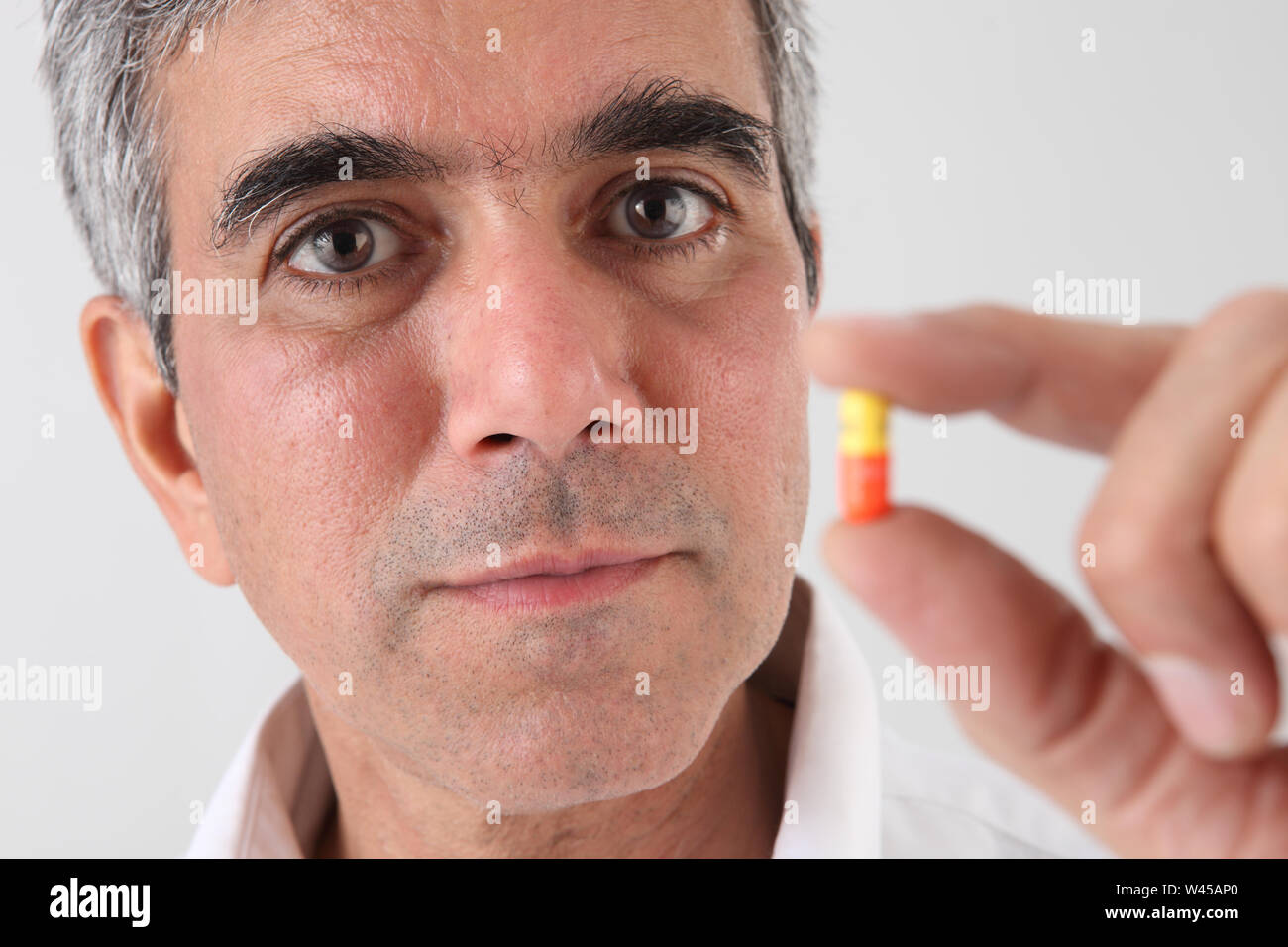 Indian old man taking medicine hi-res stock photography and images - Alamy