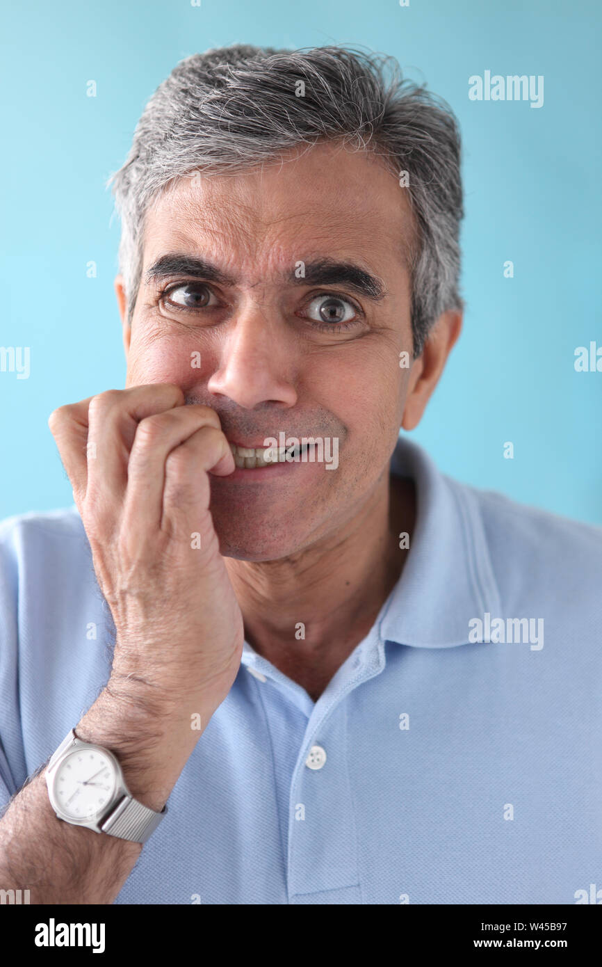 Portrait of a man biting nails Stock Photo - Alamy