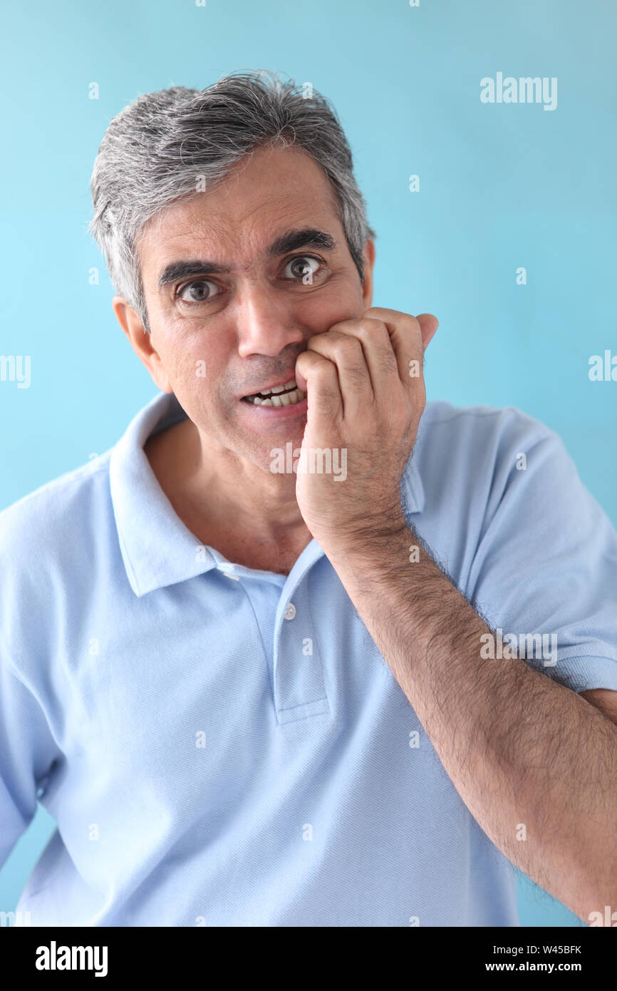 Portrait of a man biting nails Stock Photo - Alamy