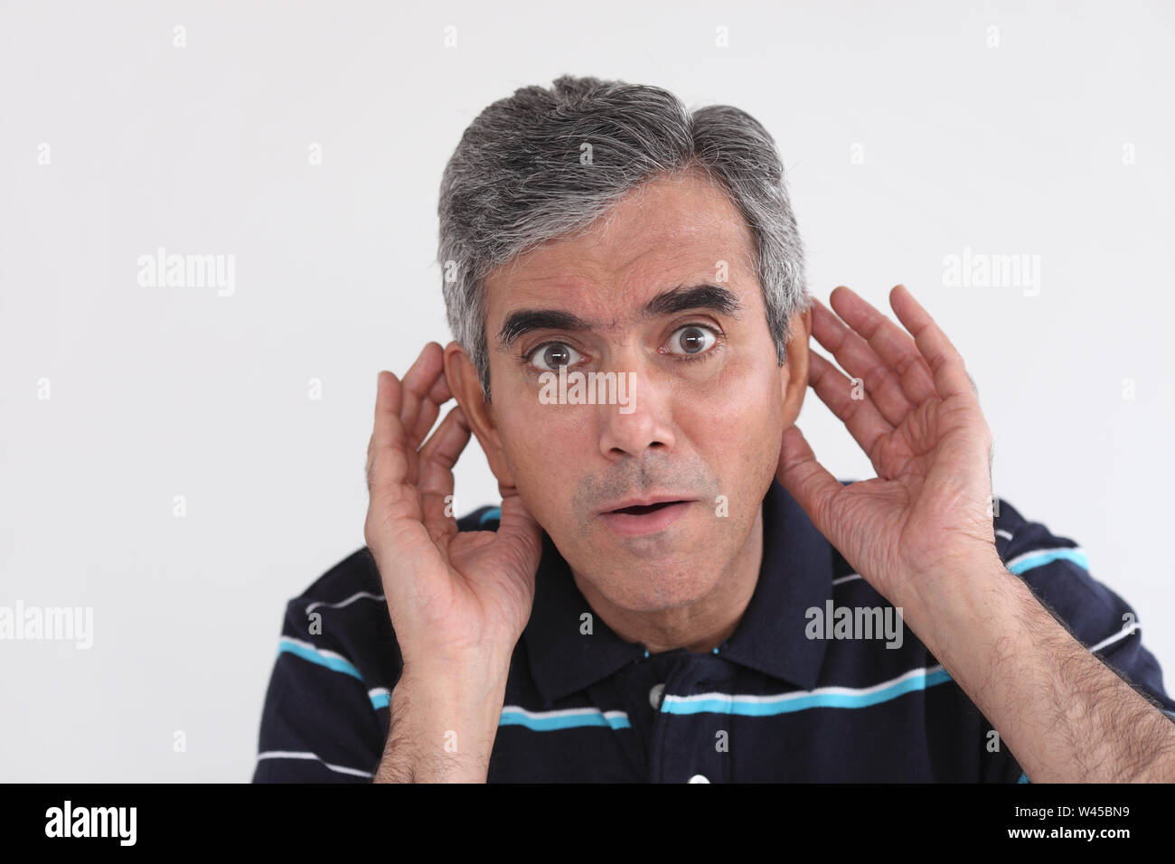 Portrait of a man trying to listen Stock Photo - Alamy