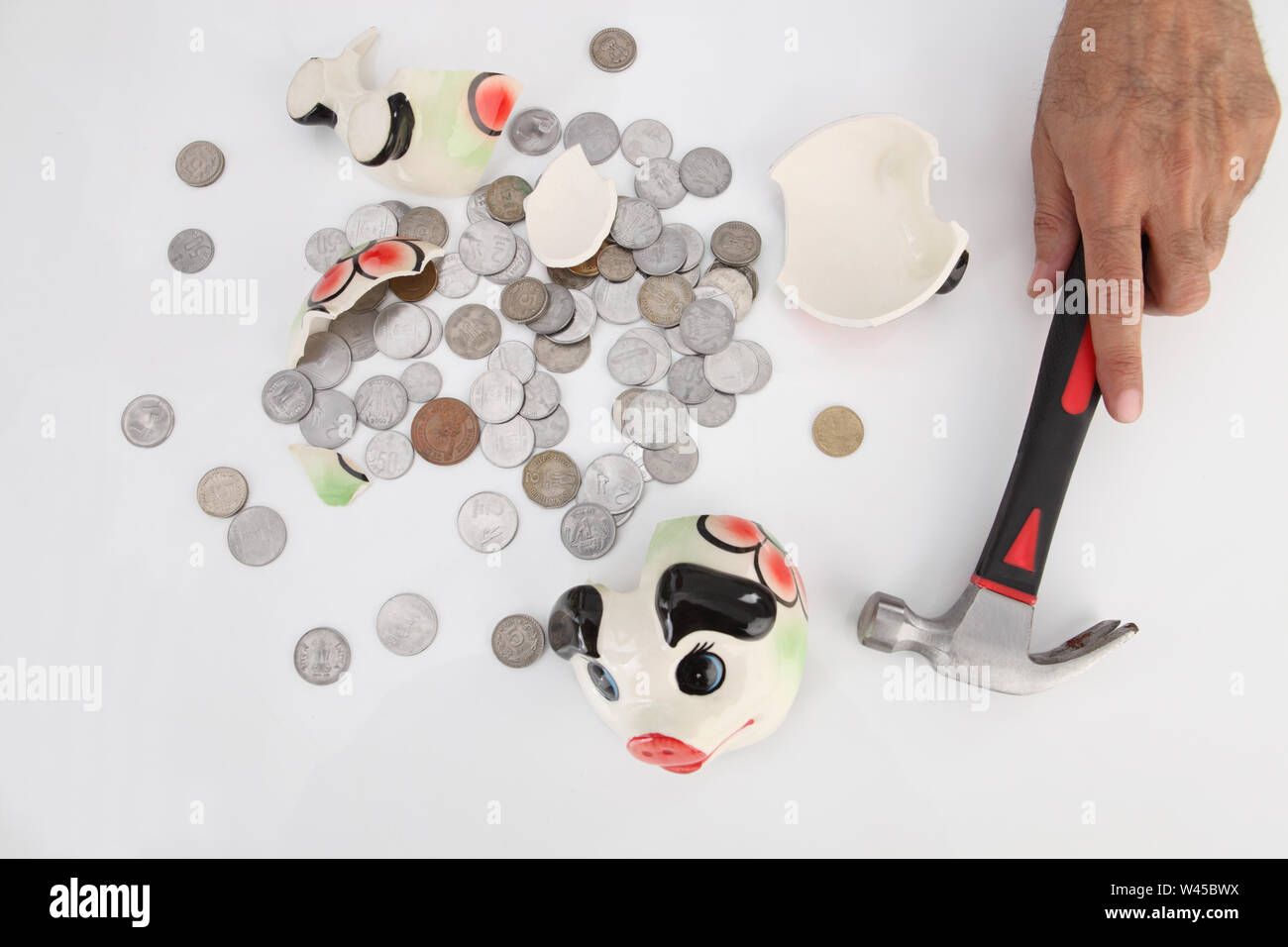 Coins with smashed piggy bank Stock Photo - Alamy