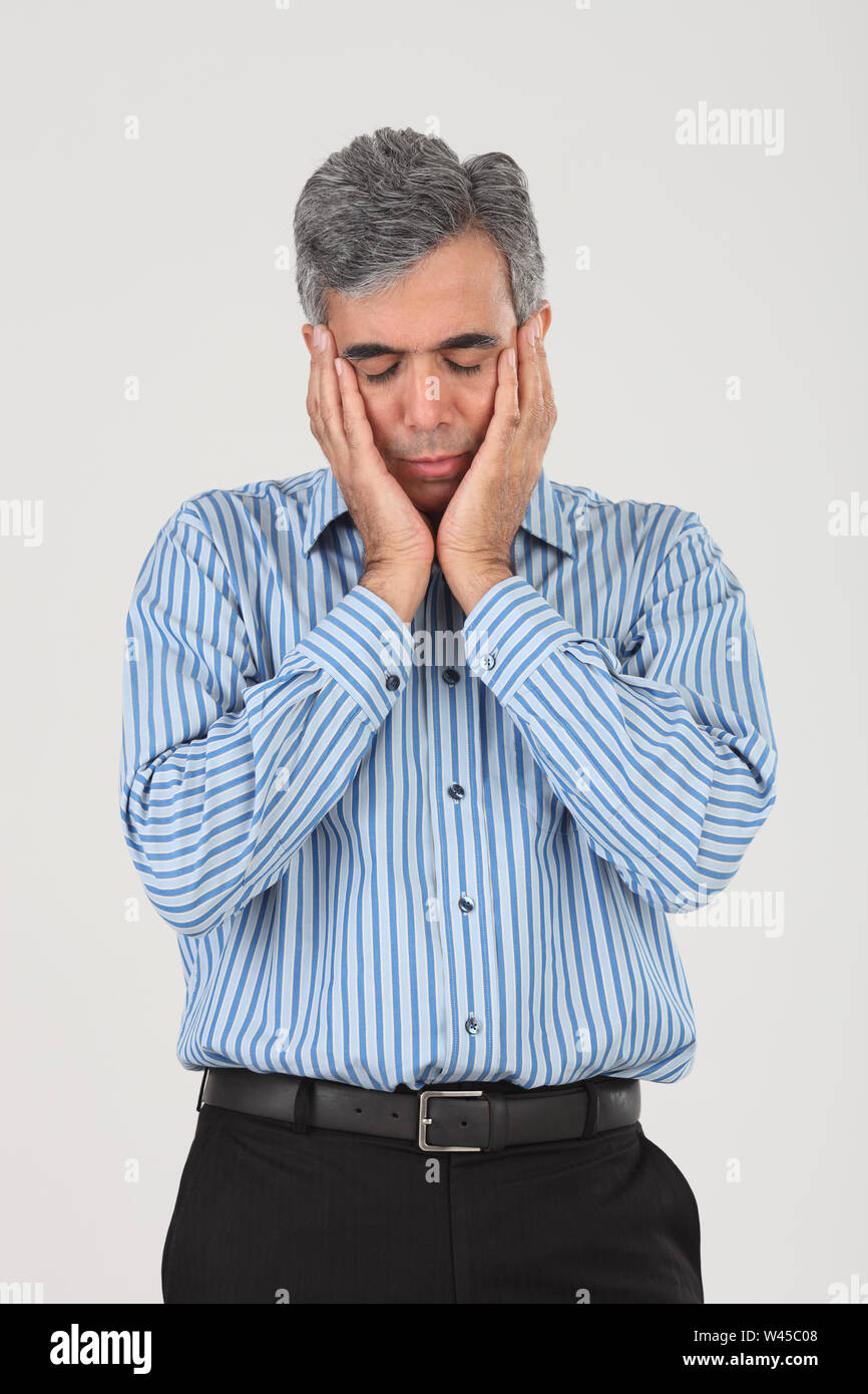 Man with head in hands Stock Photo - Alamy