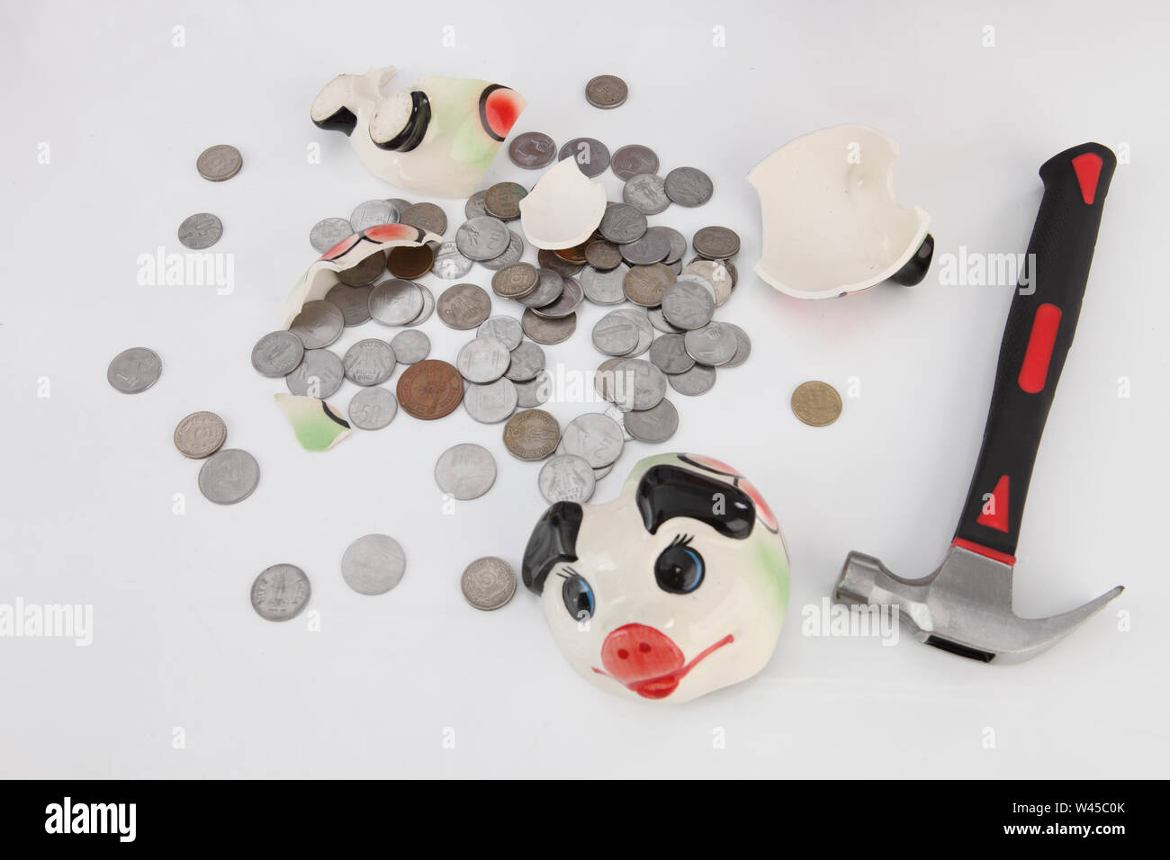 Coins with smashed piggy bank Stock Photo - Alamy