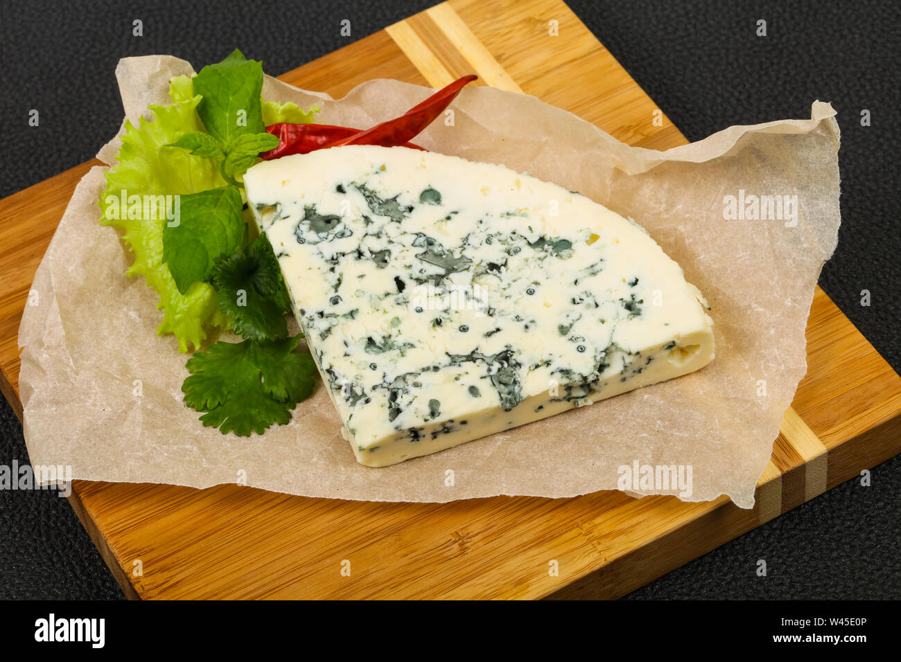 Blue cheese slice with salad leaves Stock Photo - Alamy