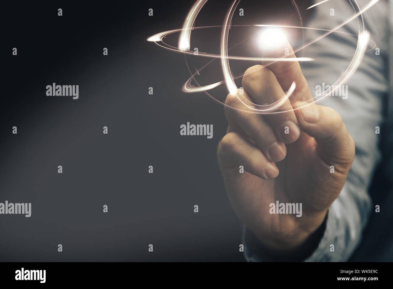 Human forefinger touches green atom. Mixed media Stock Photo - Alamy