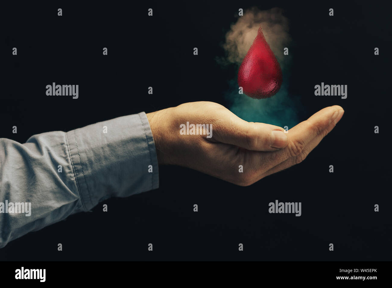 Human hand blood drop. Nebula dust in infinite space. World Blood Donor ...
