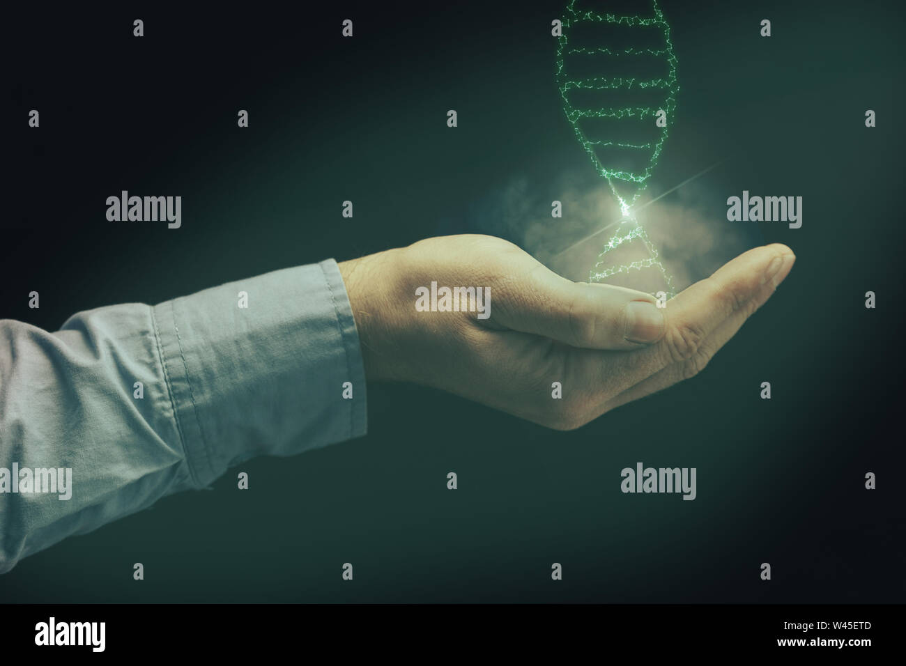 Man holding DNA molecule in palm Stock Photo - Alamy