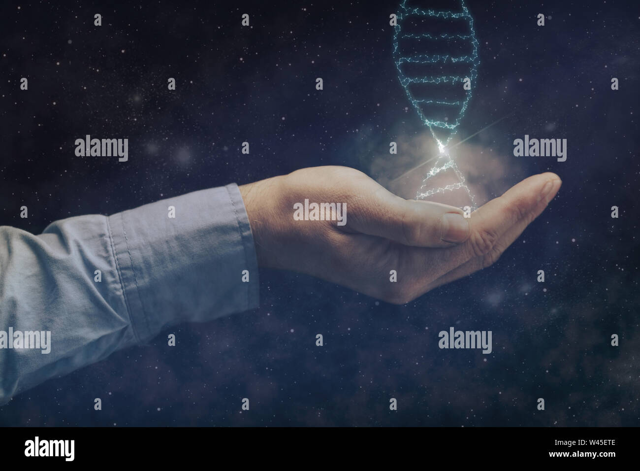 Man holding DNA molecule in palm Stock Photo - Alamy