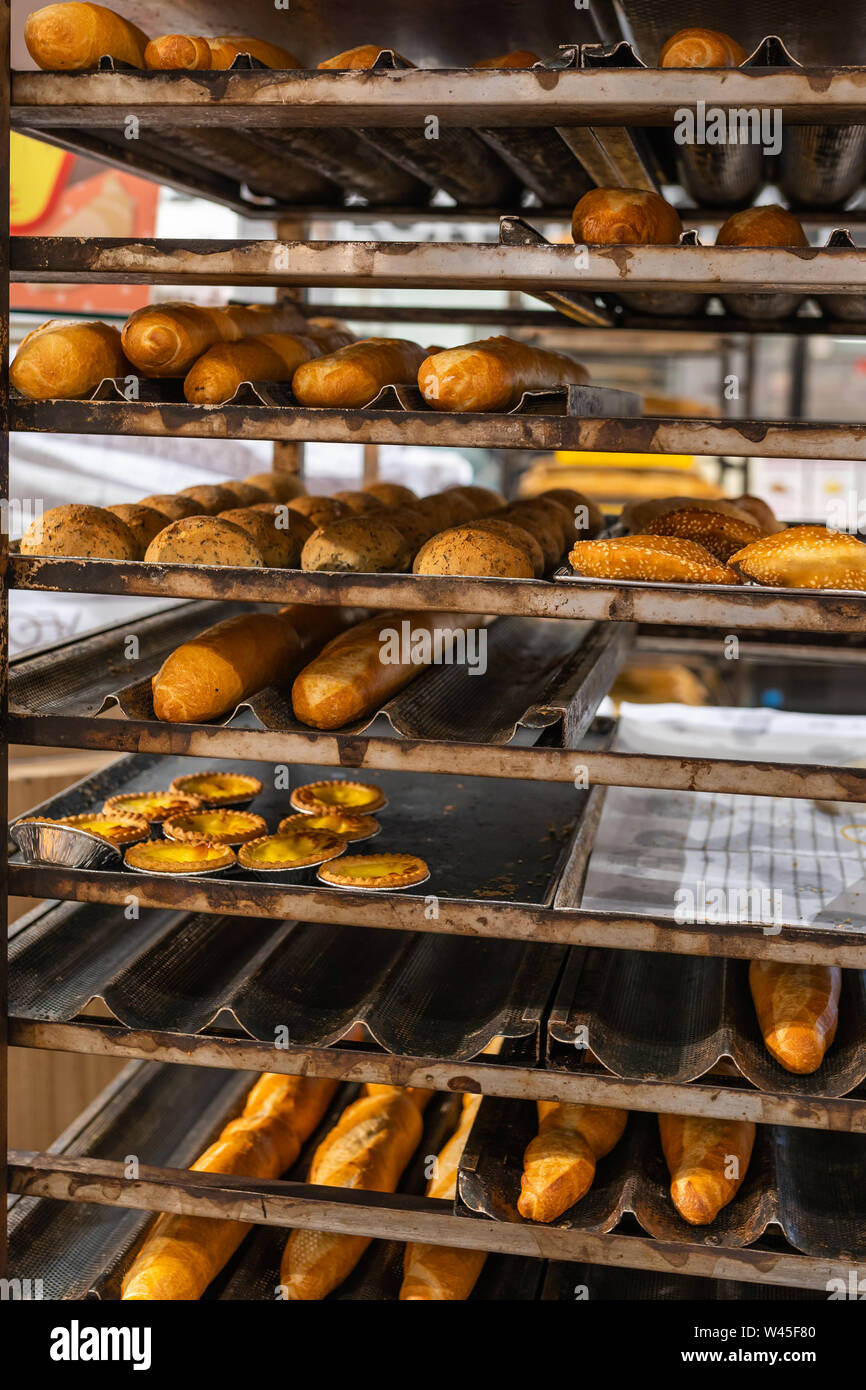 Assorted freshly baked pastry on cooling rack at confectionery factory ...