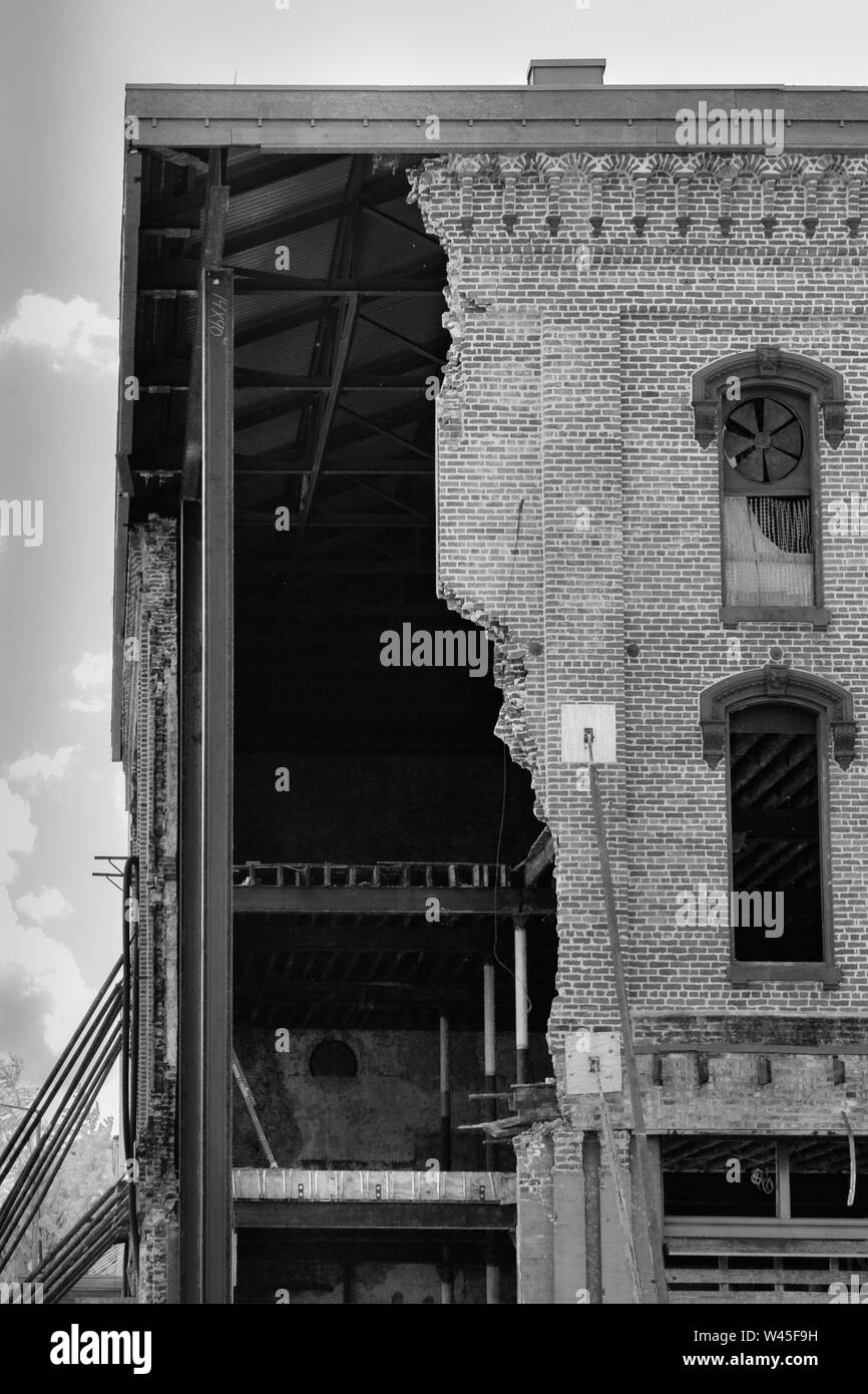 A partially demolished vintage brick building, making way for urban ...