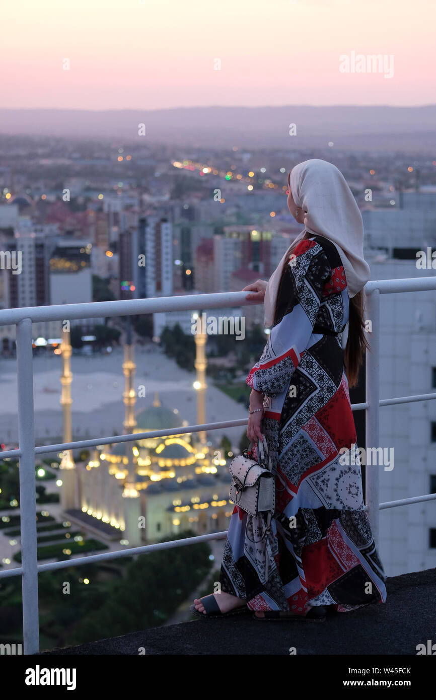 A Chechen woman gazing from an observation point of a skyscraper in ...